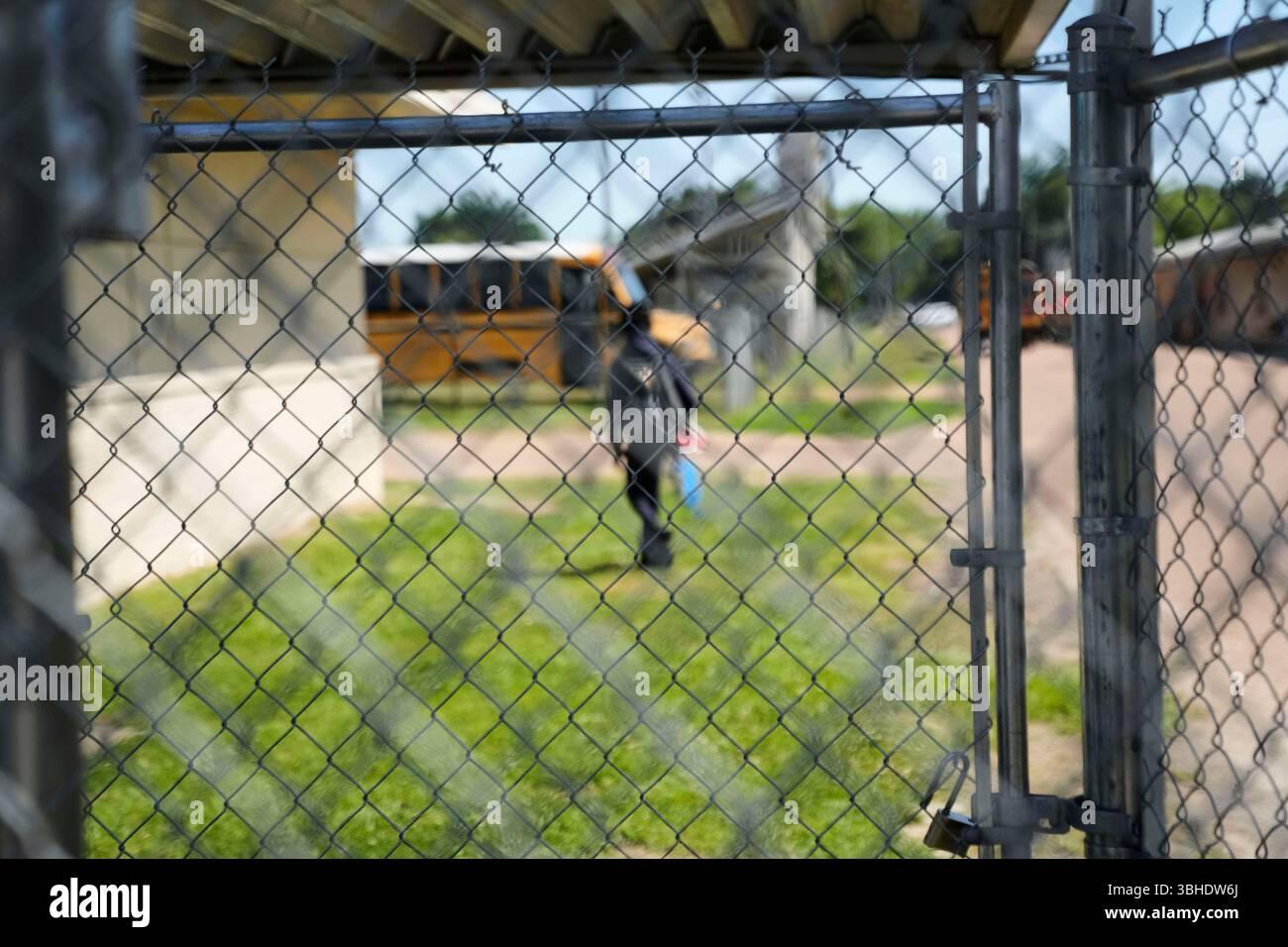 A person walks inside a barbed wire fence inside Ferriday High School ...