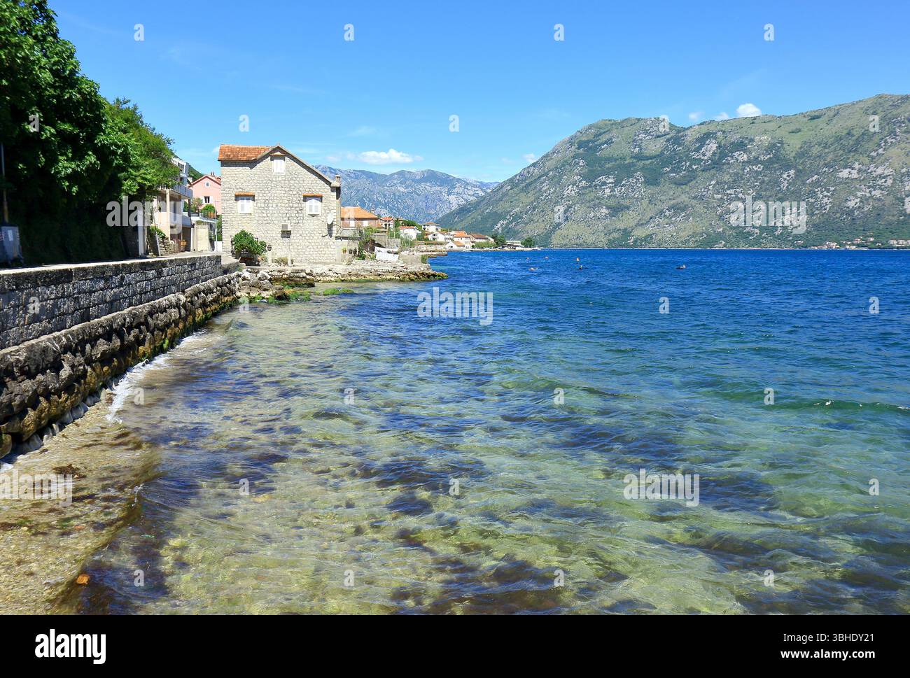 Clear water and blue sky over the Bay of Kotor Stock Photo - Alamy