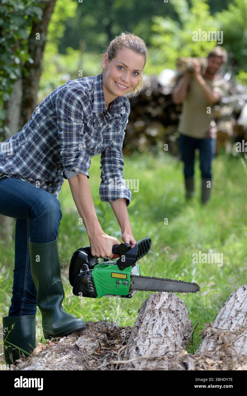 woman in the forest using a chainsaw Stock Photo - Alamy