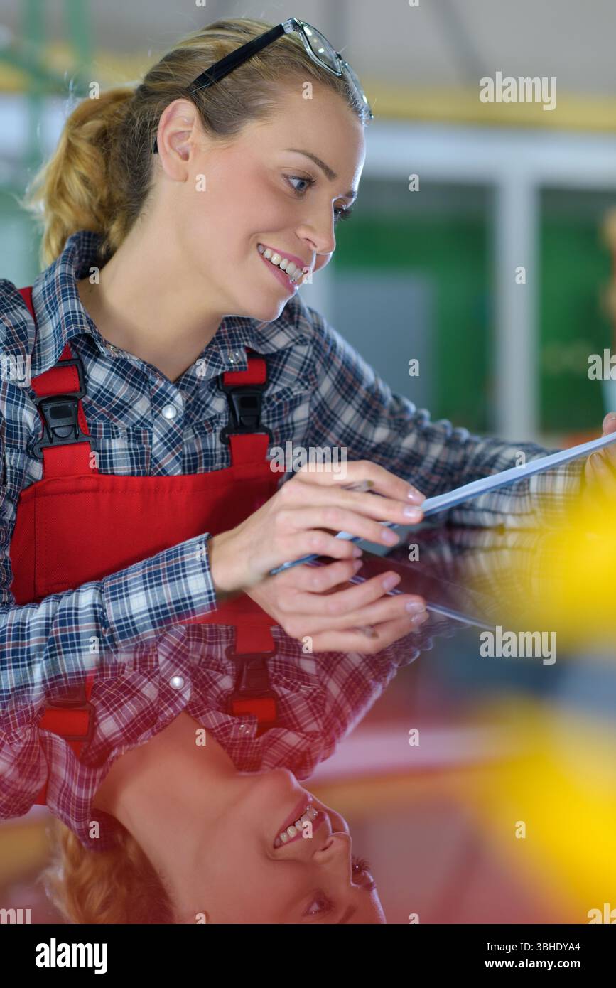 female worker wearing red dungarees Stock Photo - Alamy