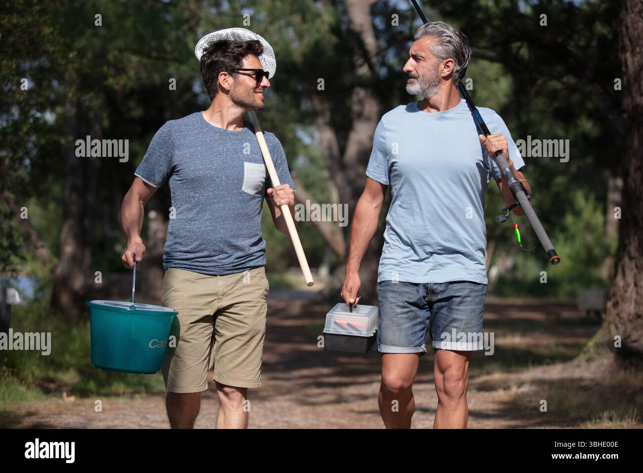 Two male fishermen fishing rods hi-res stock photography and images - Alamy