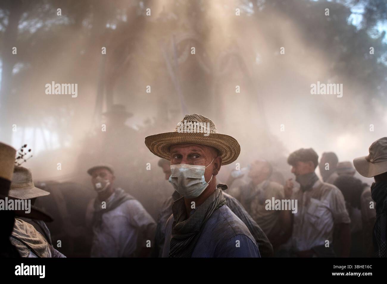 Pilgrims walk through dusty terrain near Aznalcazar, Spain, during the ...