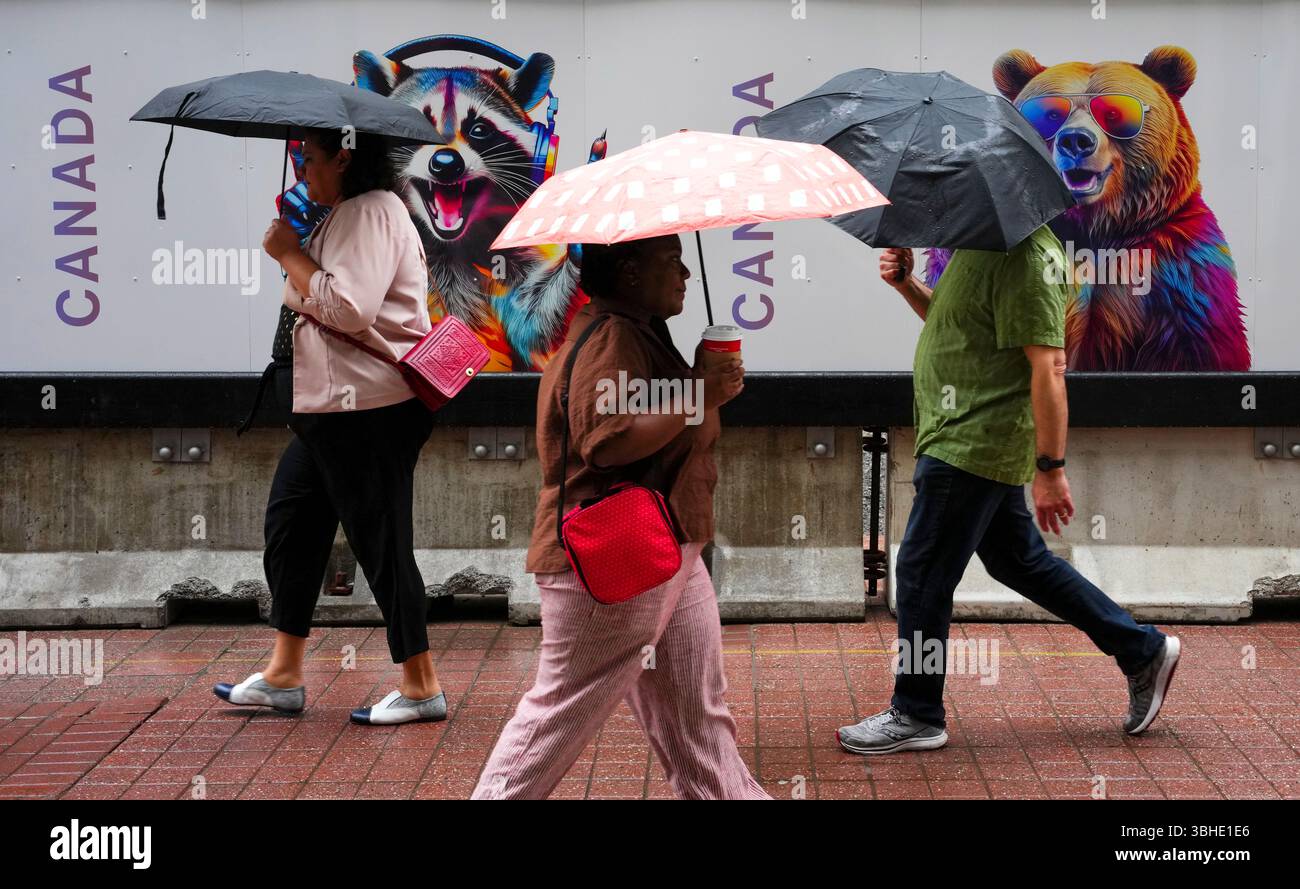 Ottawa, Canada. 09th June, 2025. People make their way through the rain ...