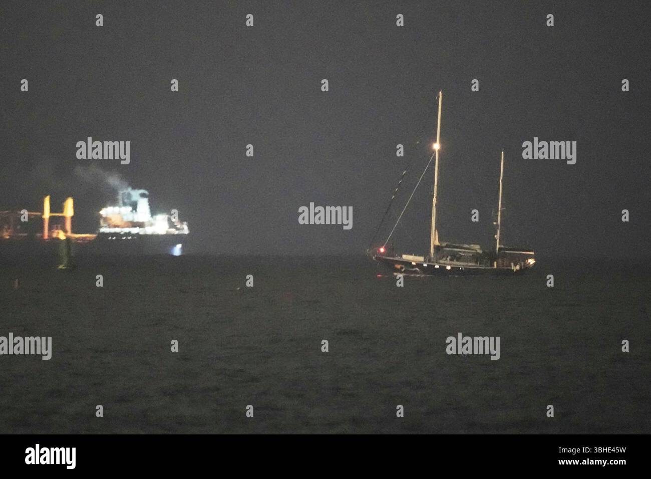 The Gaza-bound aid boat, Madleen, right, under escort of Israeli naval ...