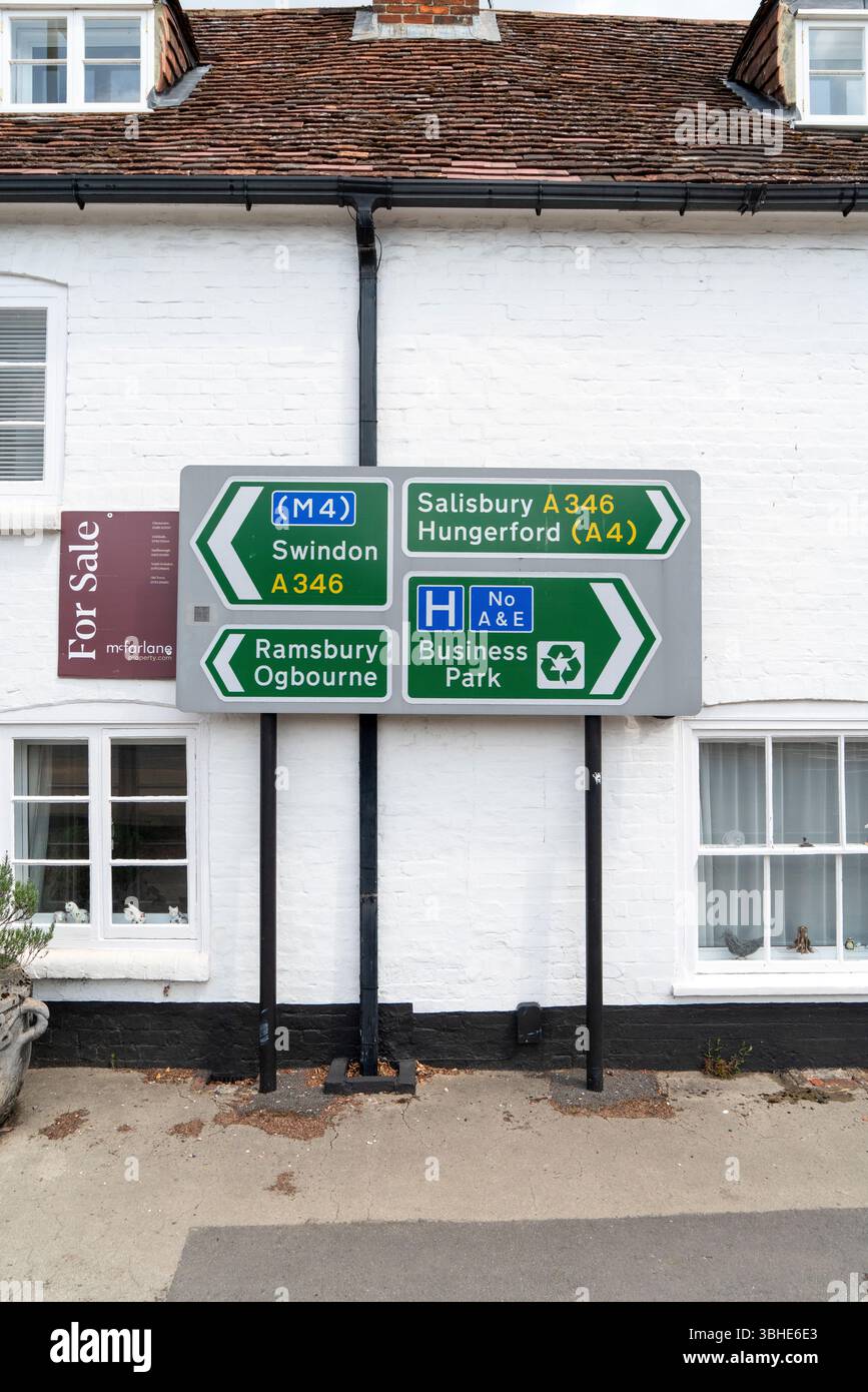 Traffic direction signs in front of a white house Stock Photo - Alamy