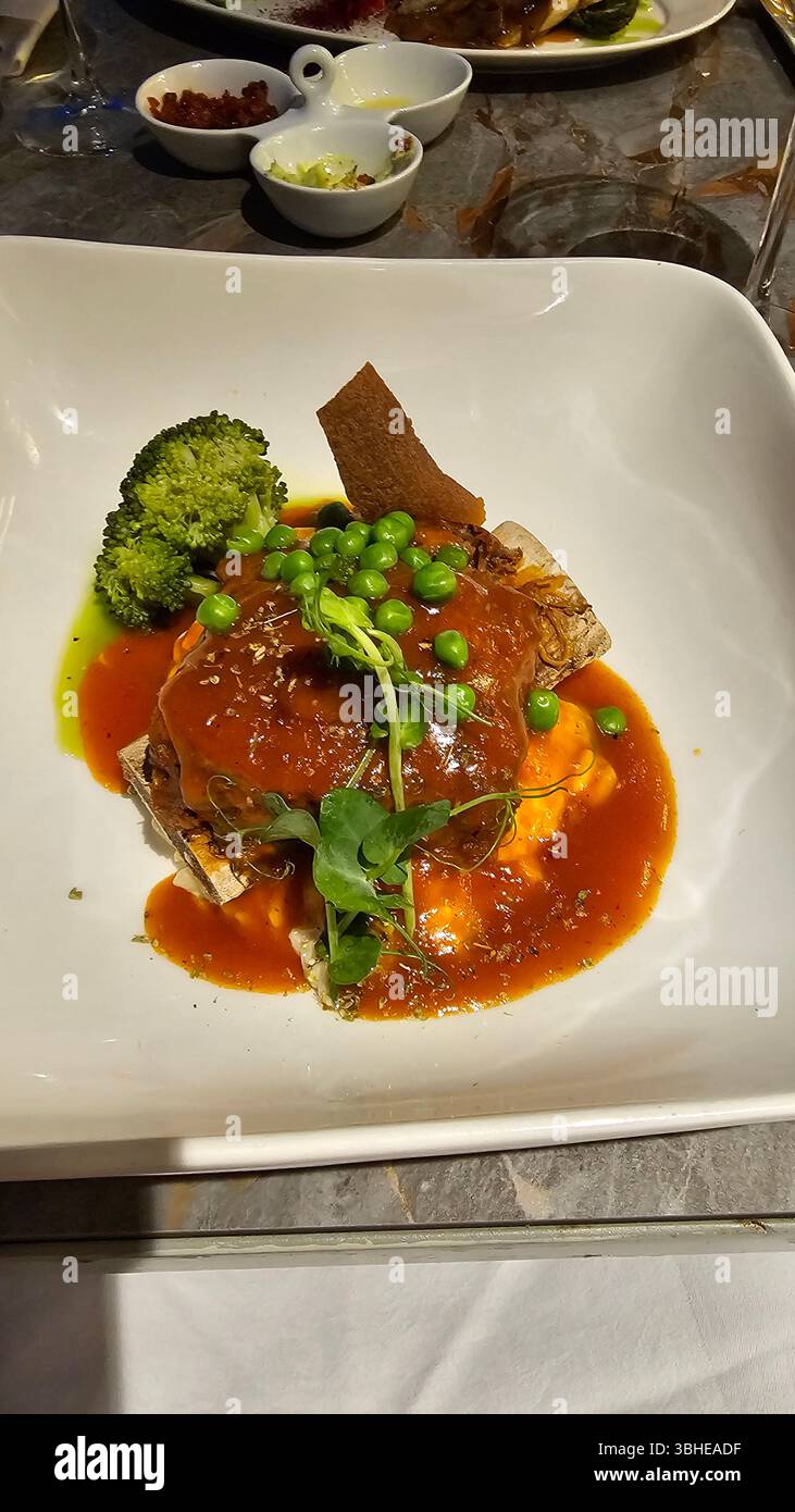 American cuisine. Large juicy grilled steak on a tomahawk bone. Beef ...