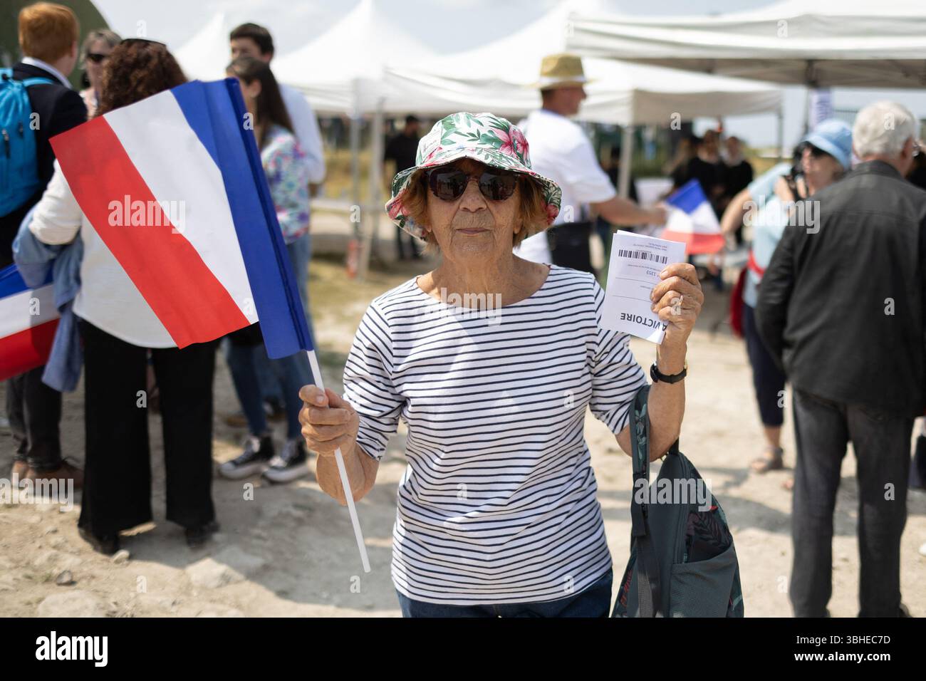 RN Supporters hold french flags as they attend the Rassemblement ...
