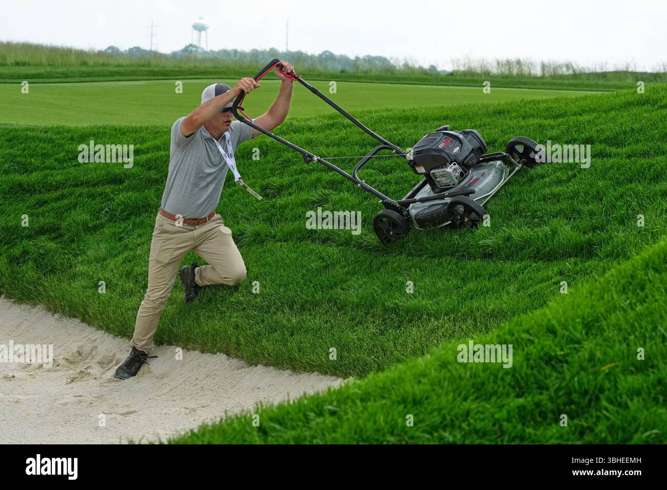 The rough surrounding a fairway bunker on the 18th hole gets cut during ...