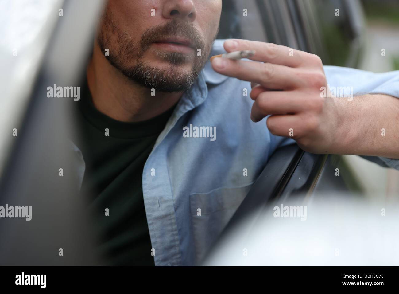 Hand cigarette in car hi-res stock photography and images - Alamy