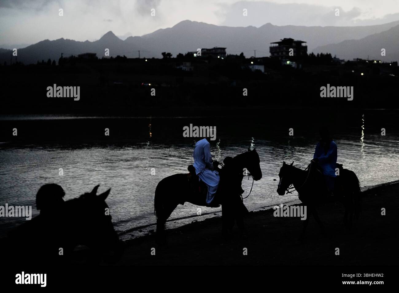 Afghan men ride horses by the lake Qargha in Kabul, Afghanistan, Monday ...
