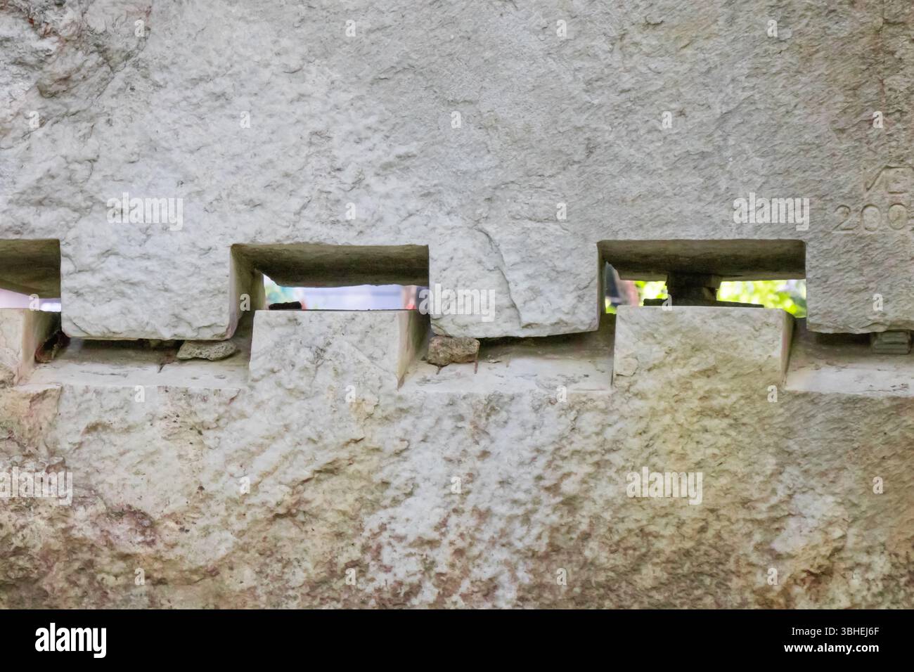 Intricate cutouts on a weathered stone wall reveal ancient ...