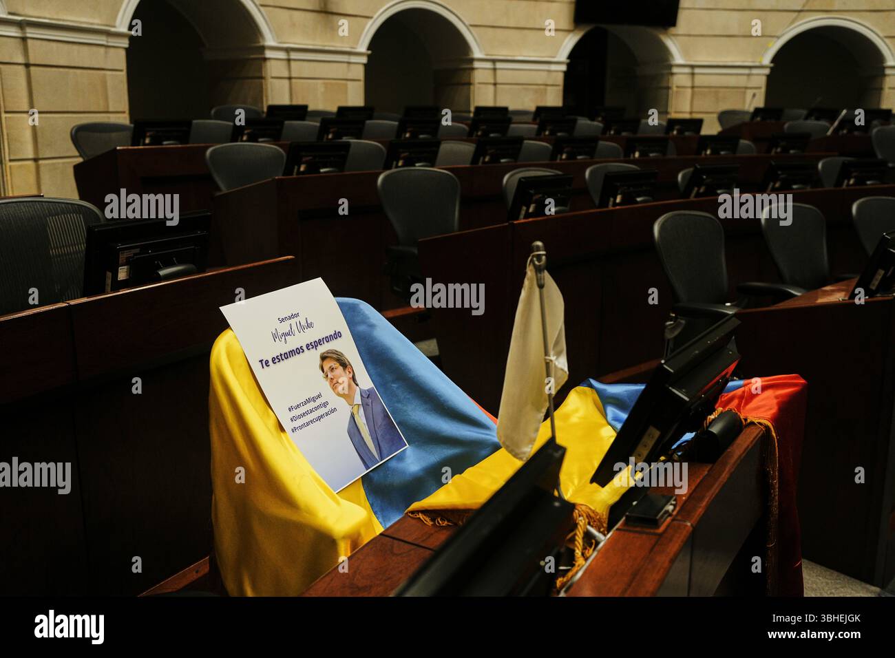 A picture of Colombian Senator Miguel Uribe Turbay and a Colombian flag ...