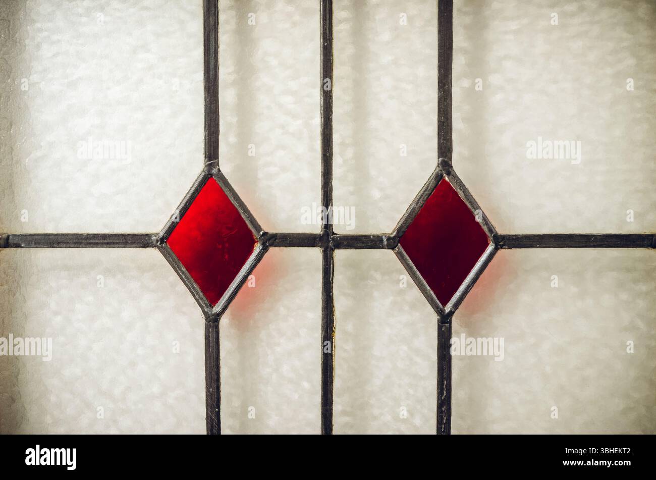 Close-up of leaded stained glass window with red diamond patterns Stock ...
