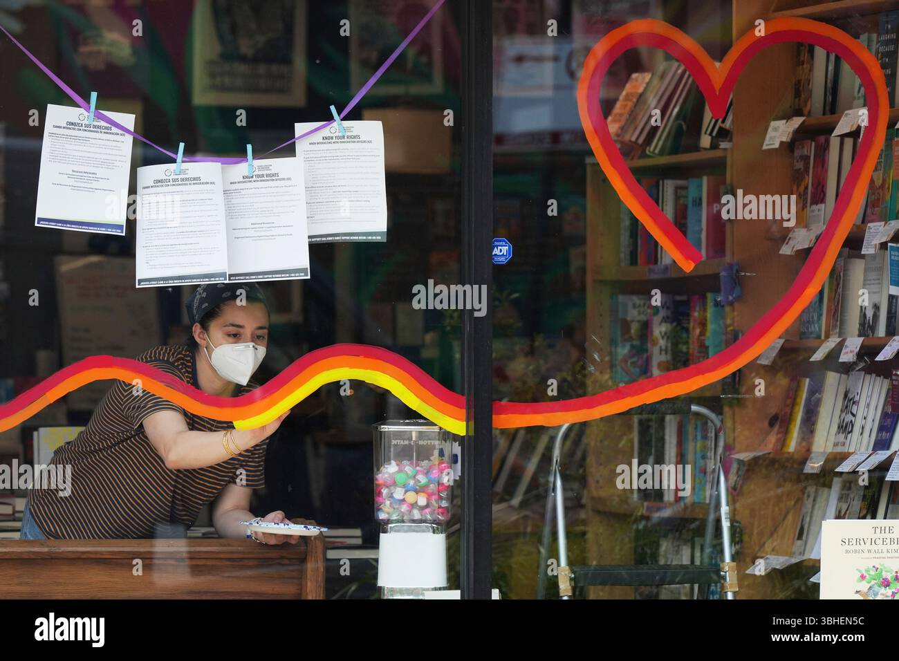An employee paints at a retail store in Chicago, Monday, June 9, 2025 ...