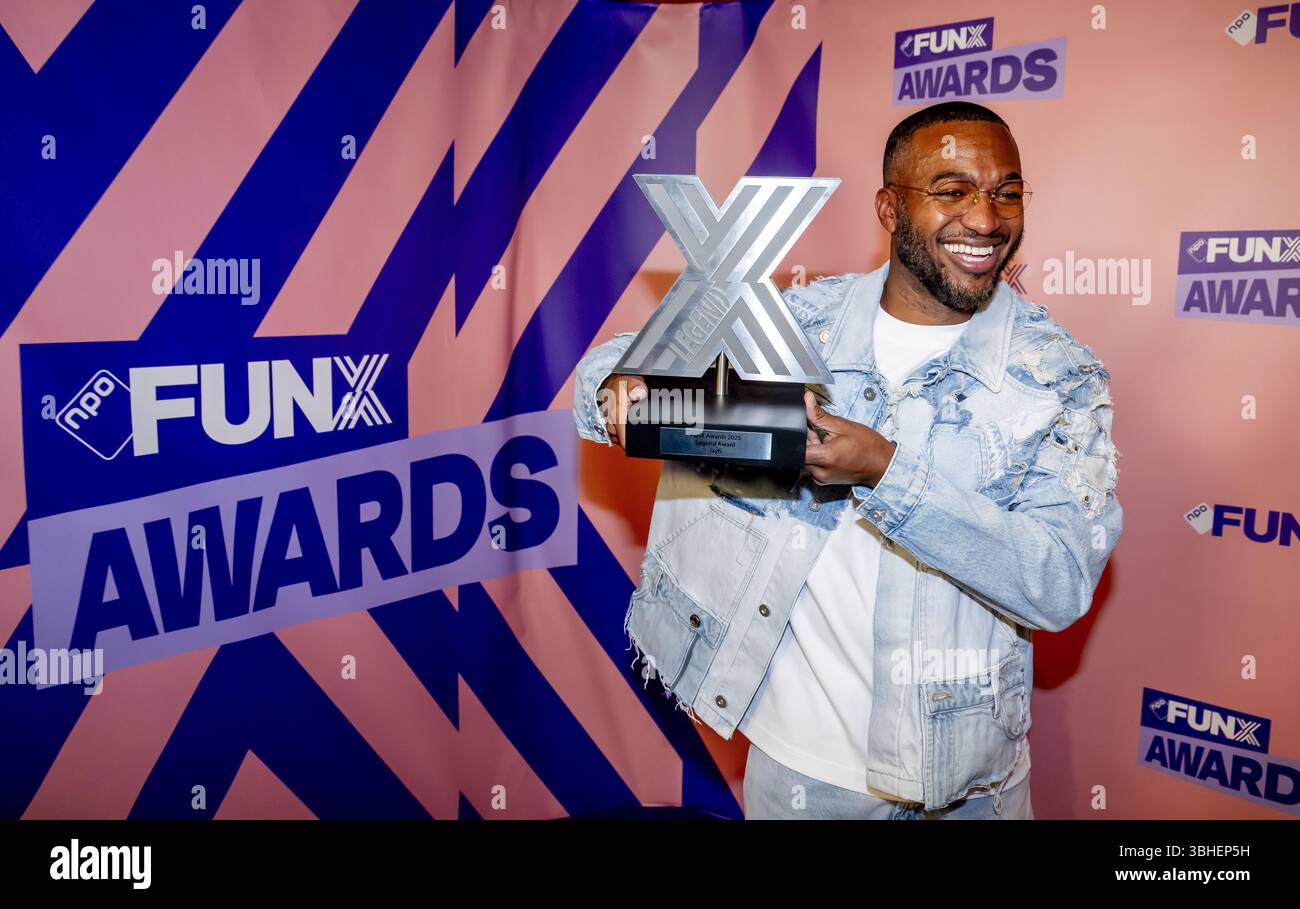 AMSTERDAM - jayh jawson shows off the award won on the purple carpet ...