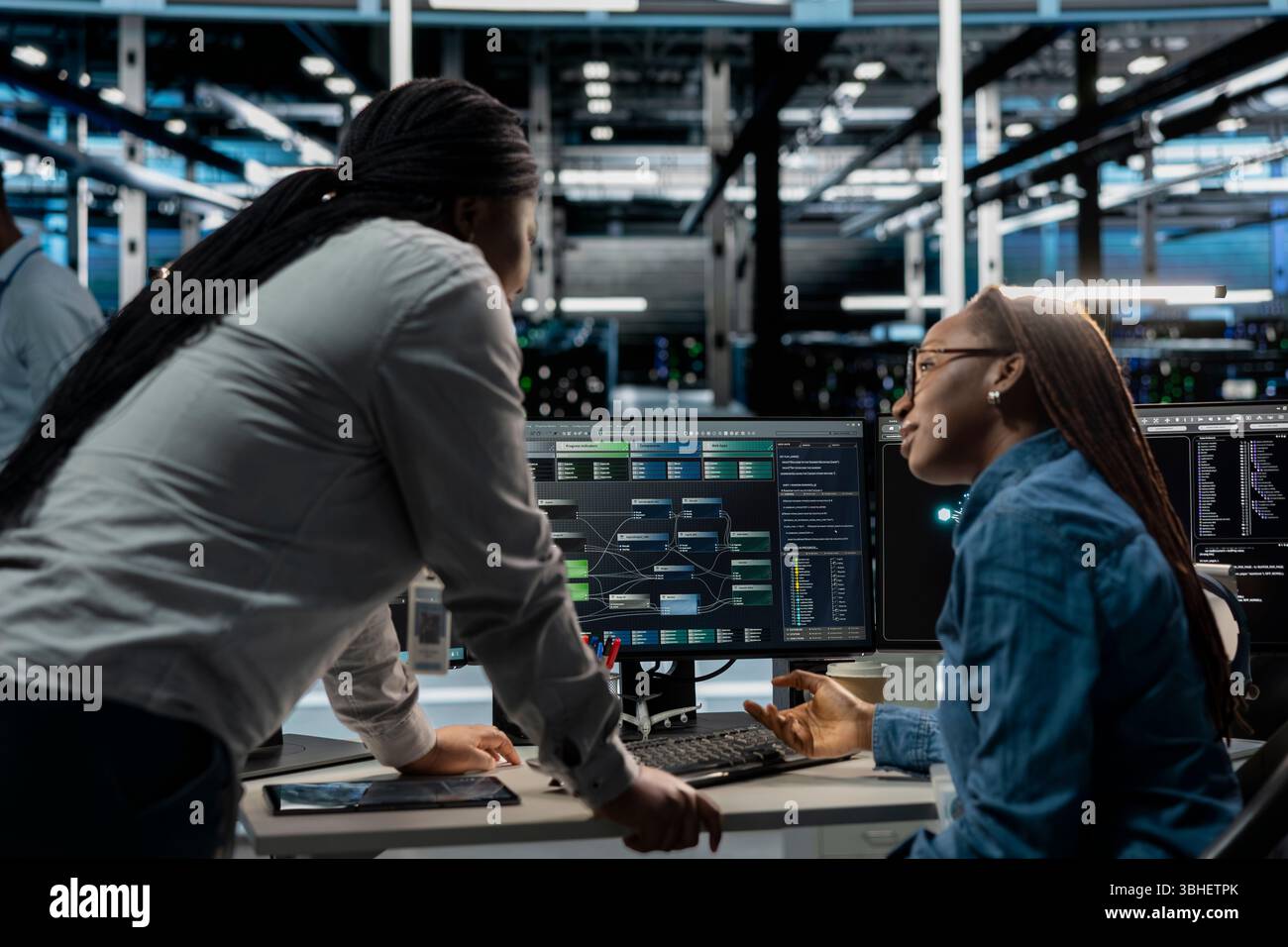 Data center manager supervising work done by engineer using artificial intelligence neural ...