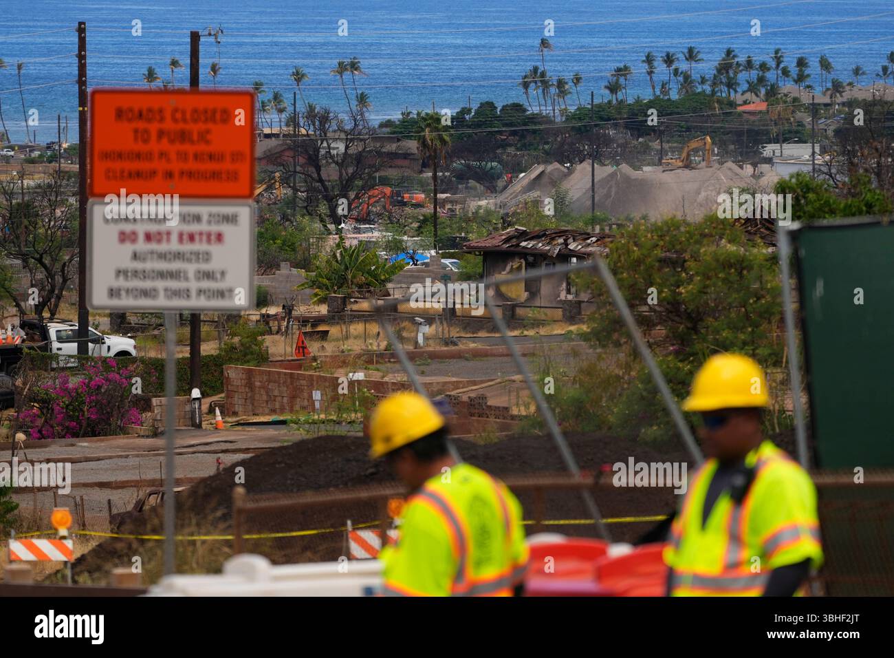 FILE - Crews work to clean debris and repave roads, Saturday, July 6 ...