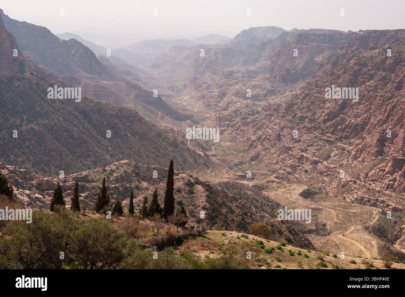 A mountain range with a valley in between. The valley is barren and ...