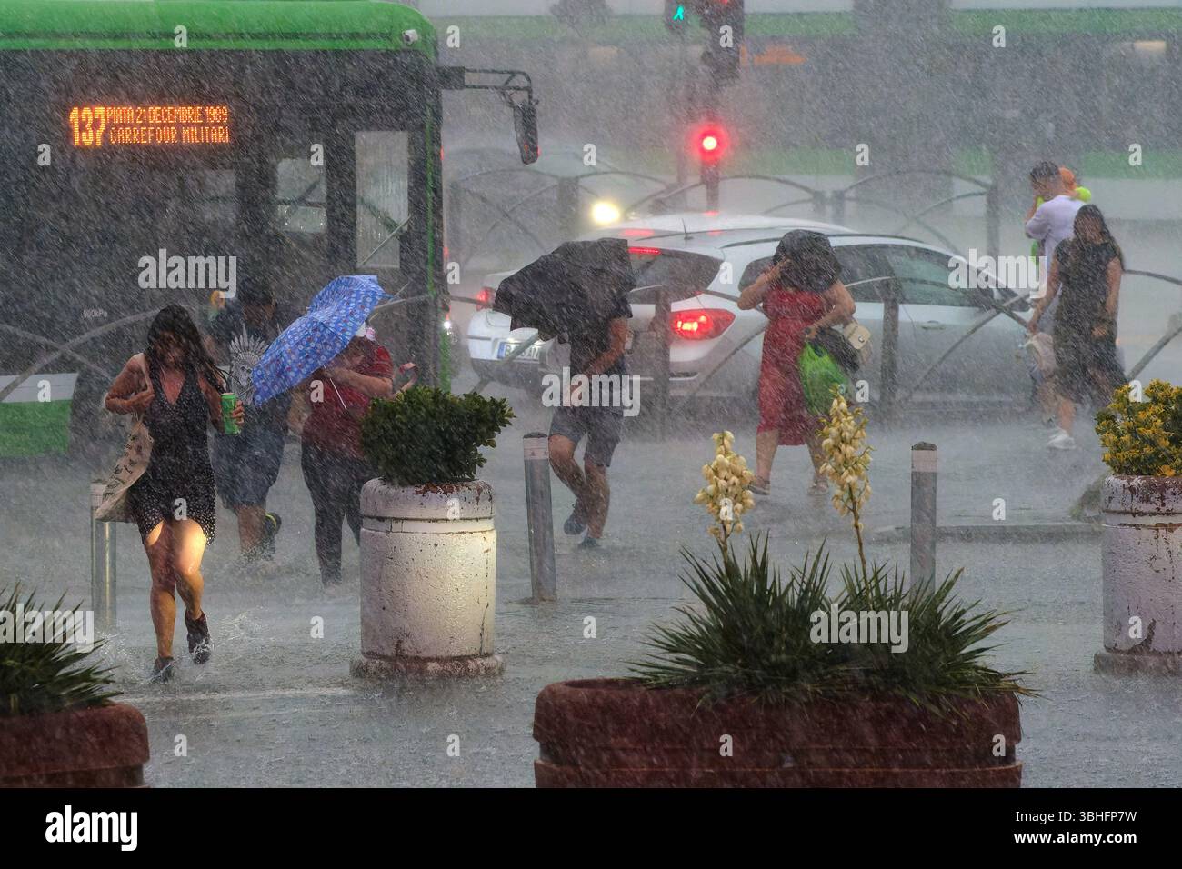 Bucharest, Romania. 9th Jun, 2025: People cross a heavily flooded ...