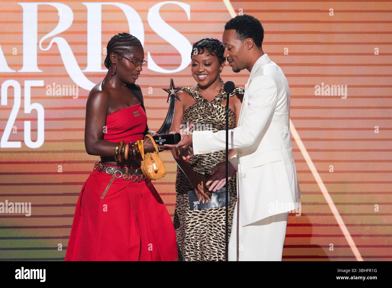 Quinta Brunson, center, and Tyler James Williams, right, present the ...