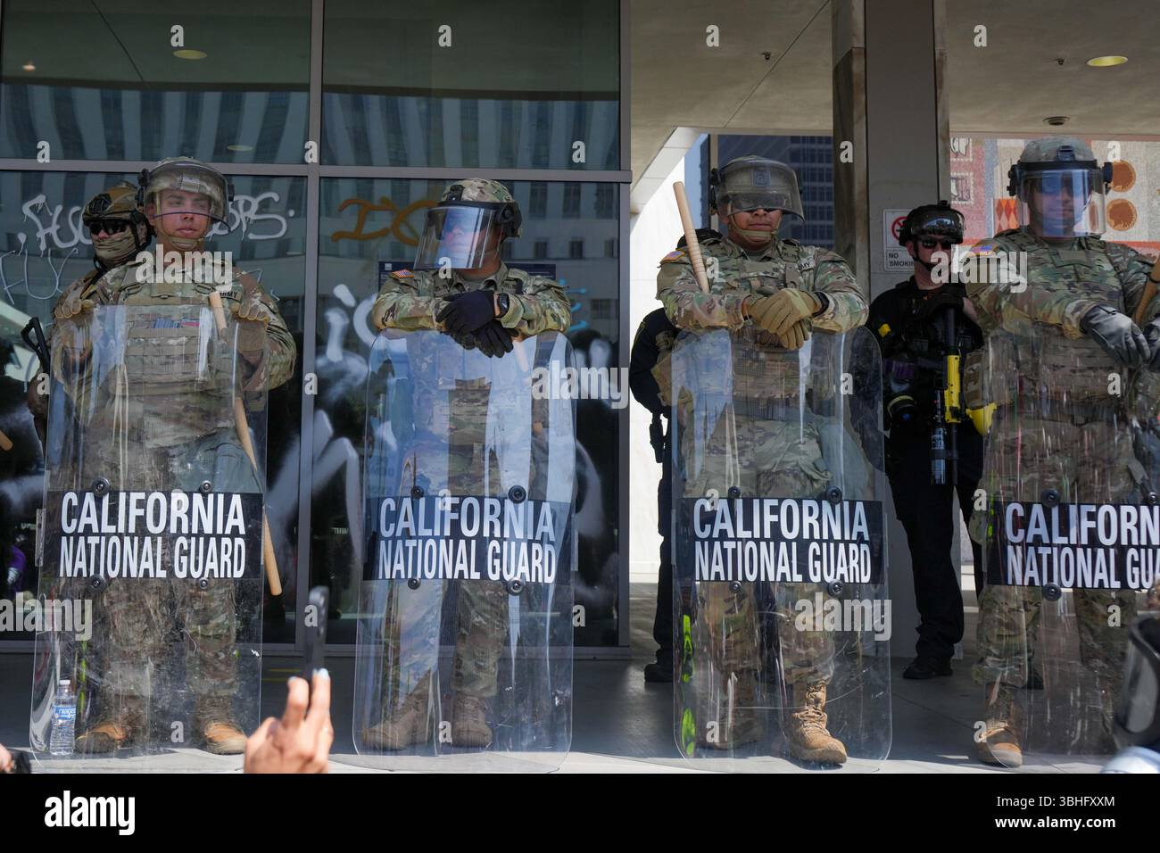 Protestors and California National Guard gather outside the Edward R ...