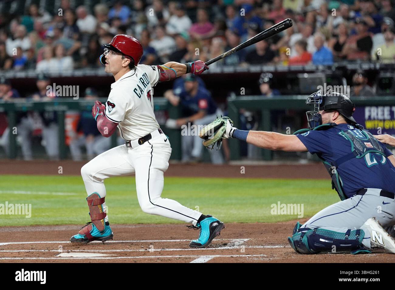 Arizona Diamondbacks' Corbin Carroll, left, watches the flight of his ...
