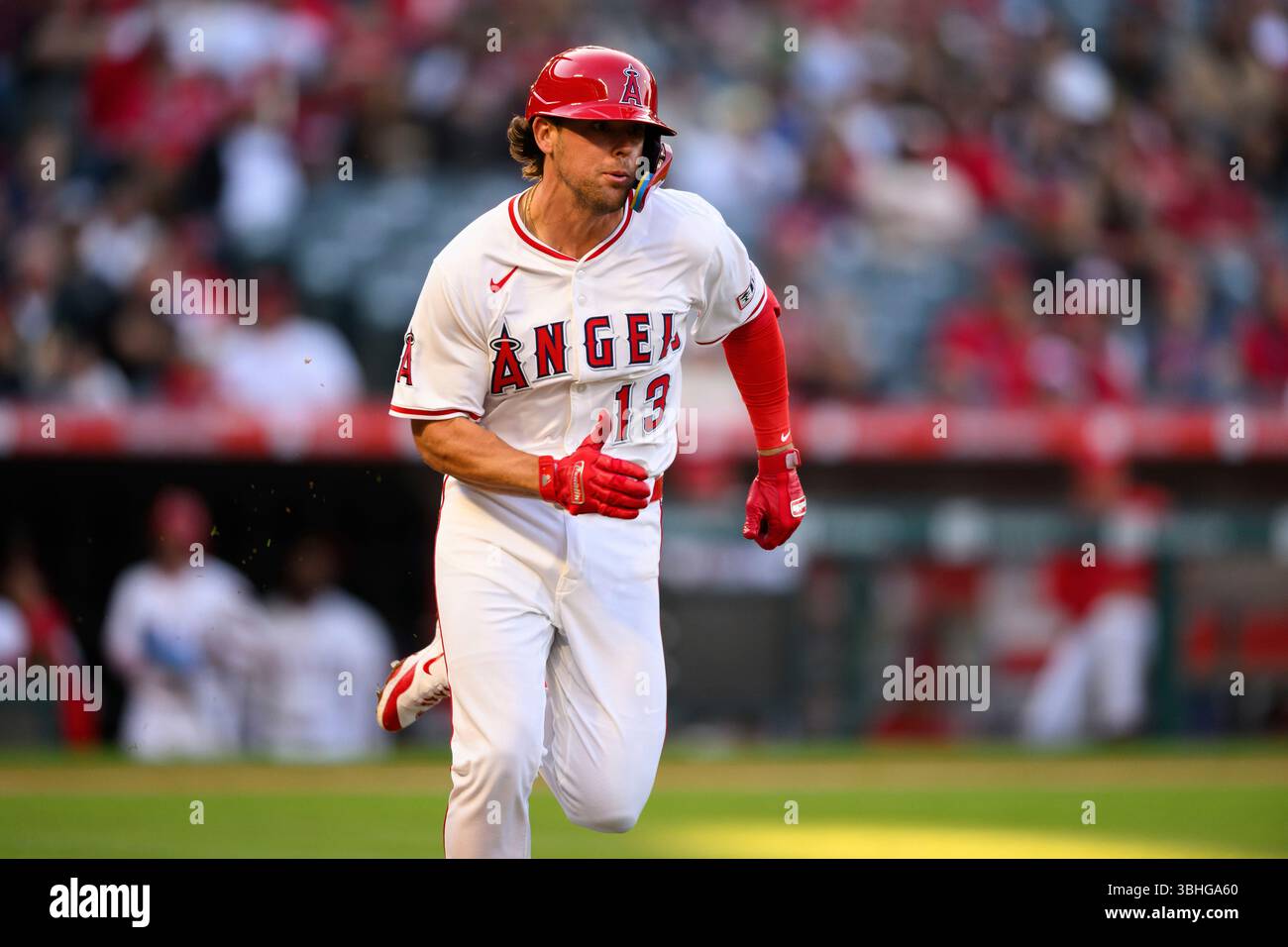 Los Angeles Angels' Scott Kingery runs to first after bunting the ball ...