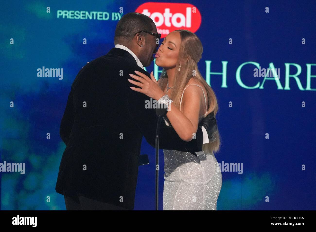 Busta Rhymes, left, presents the ultimate icon award to Mariah Carey during the BET Awards on ...