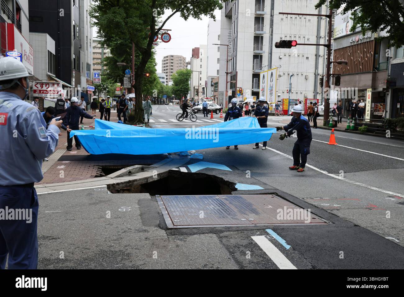 A photo shows collapsed road and sidewalk near Tenjin district in Chuo ...