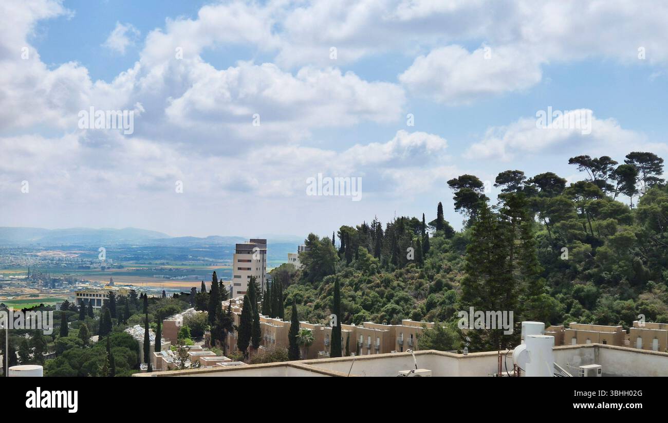 Expansive cityscape view with residential buildings, hills, and distant ...