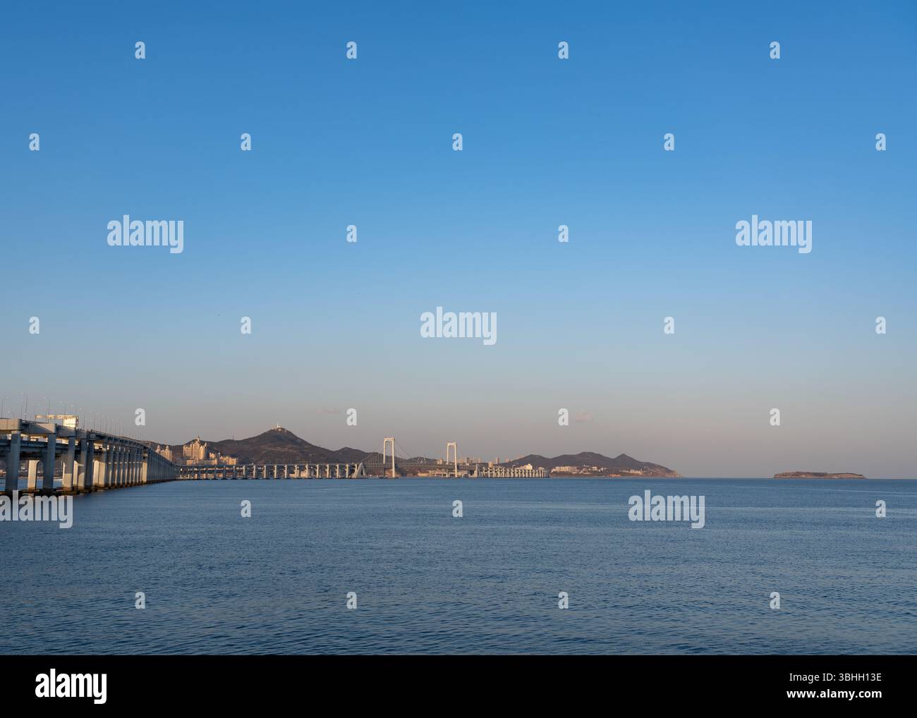 cross-sea bridge and the mount on land, before the sunset, Xinghai Bay ...