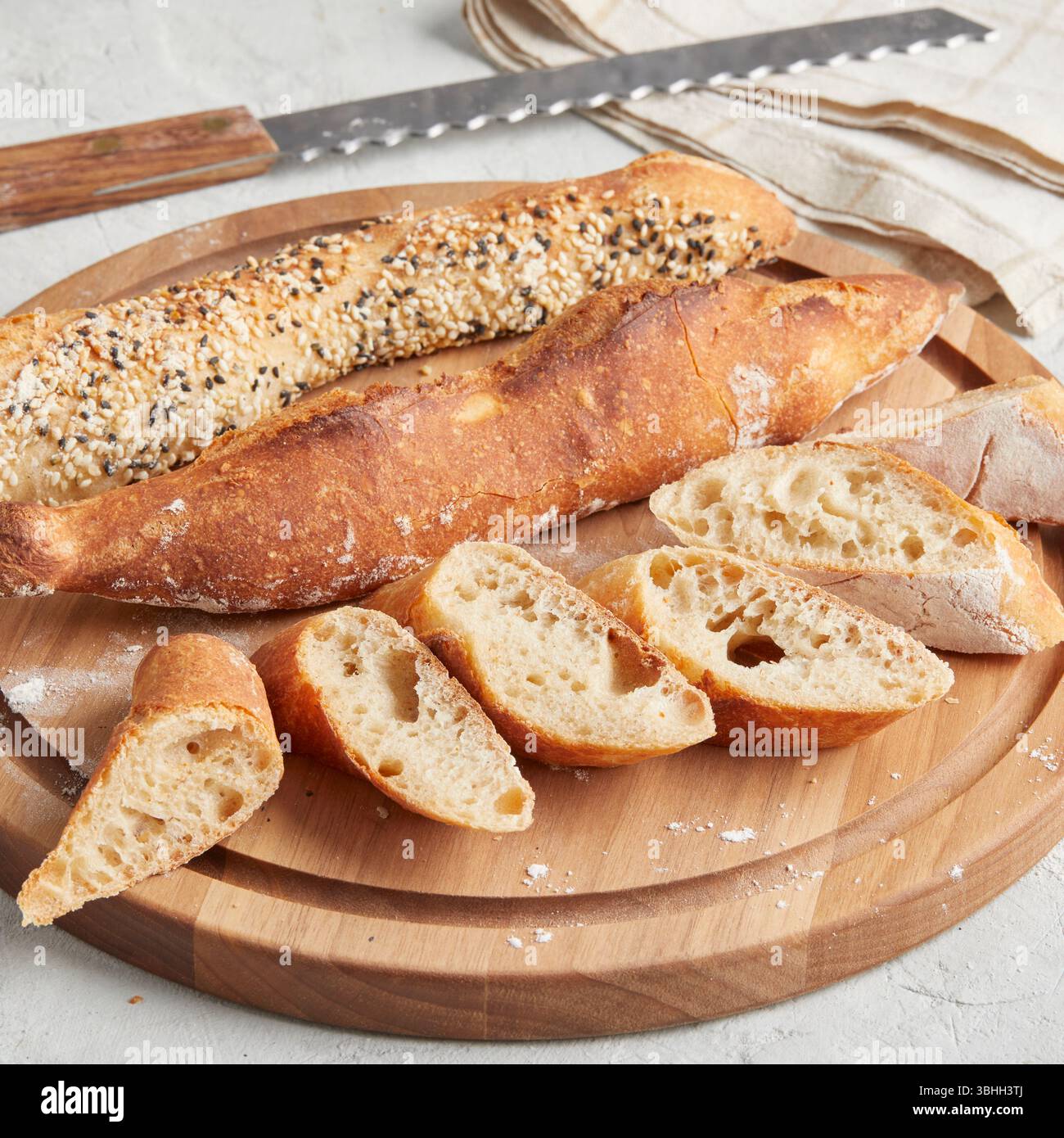 Baguette on cooling rack and wood surface – a rustic artisan loaf with ...