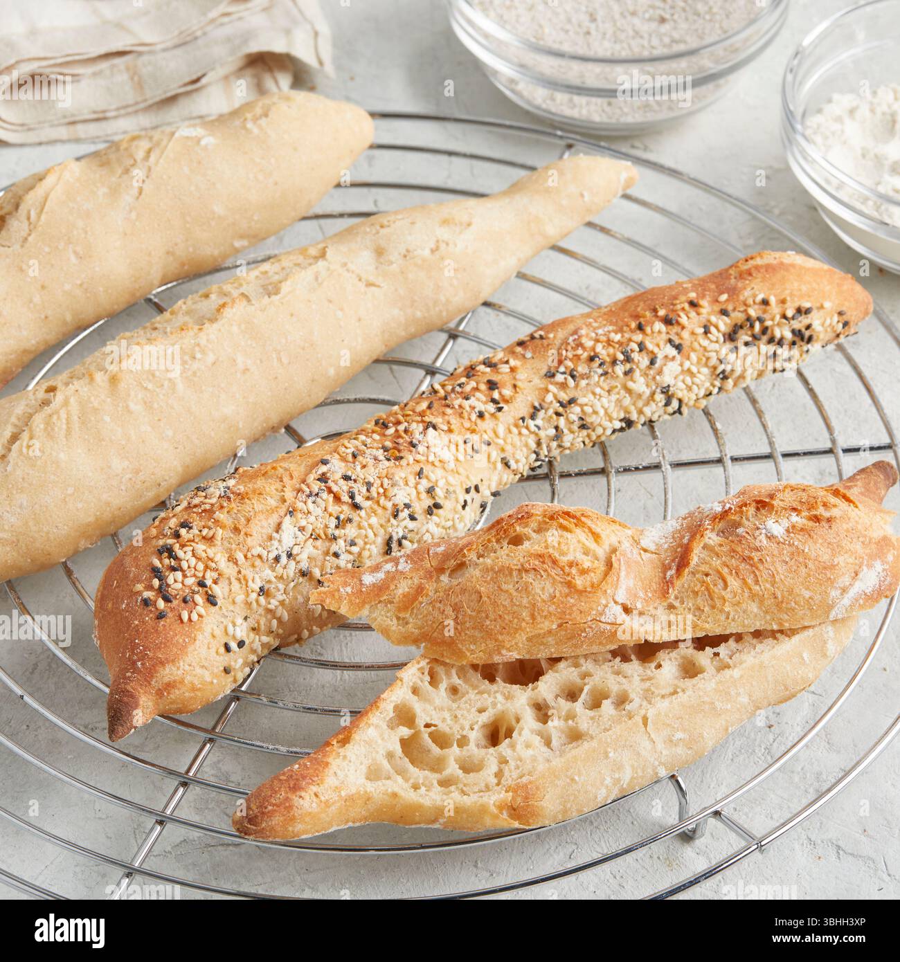 Baguette on cooling rack and wood surface – a rustic artisan loaf with ...