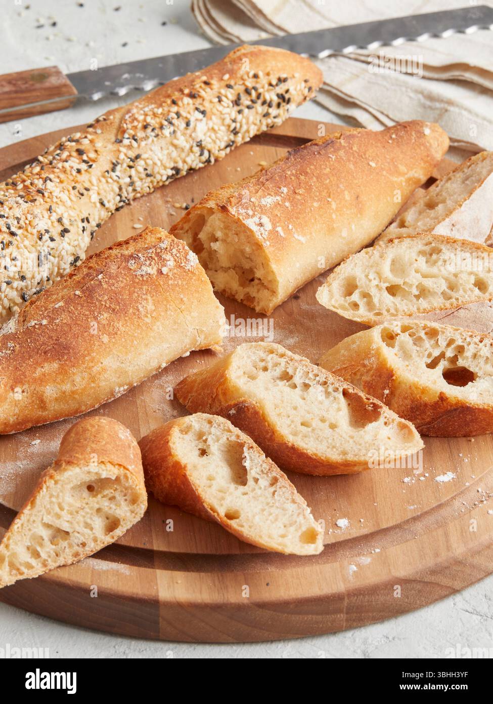 Baguette on cooling rack and wood surface – a rustic artisan loaf with ...