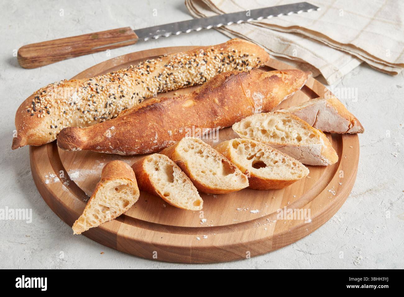Baguette on cooling rack and wood surface – a rustic artisan loaf with ...