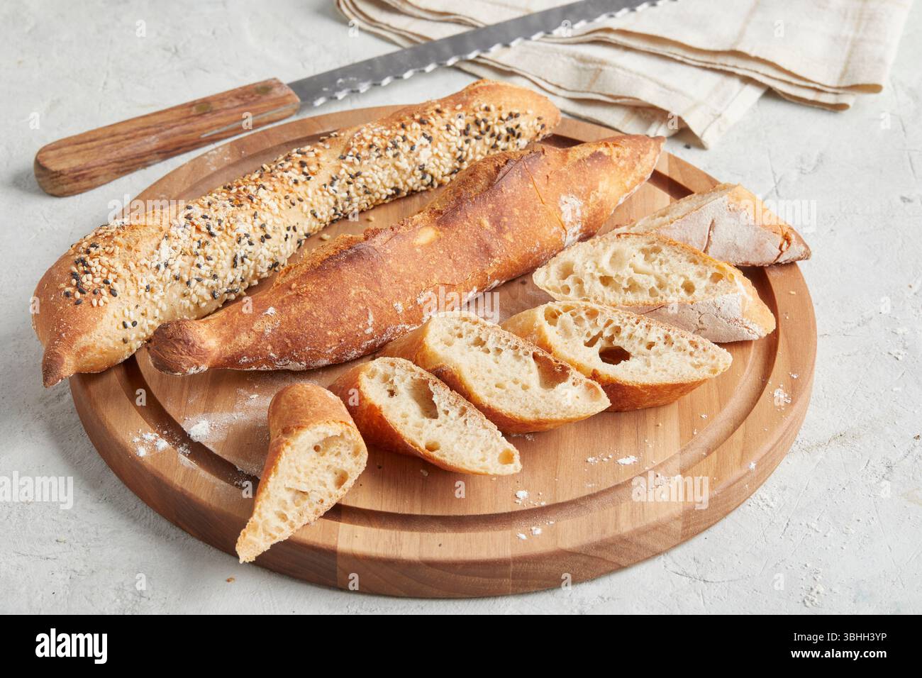 Baguette on cooling rack and wood surface – a rustic artisan loaf with ...