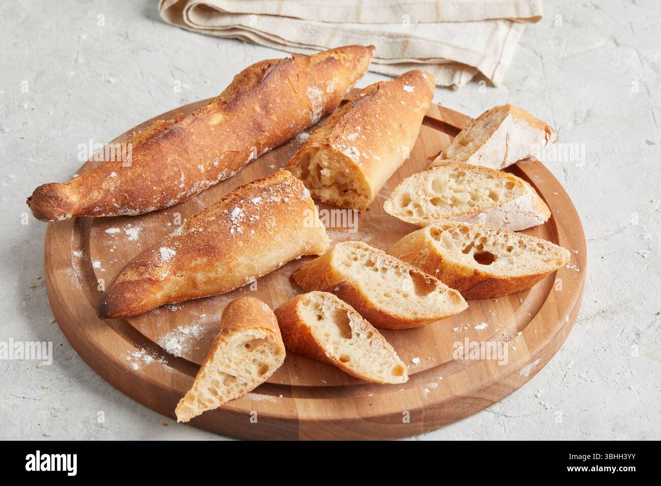Baguette on cooling rack and wood surface – a rustic artisan loaf with ...