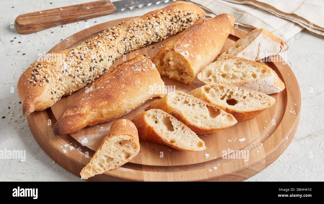 Baguette on cooling rack and wood surface – a rustic artisan loaf with ...