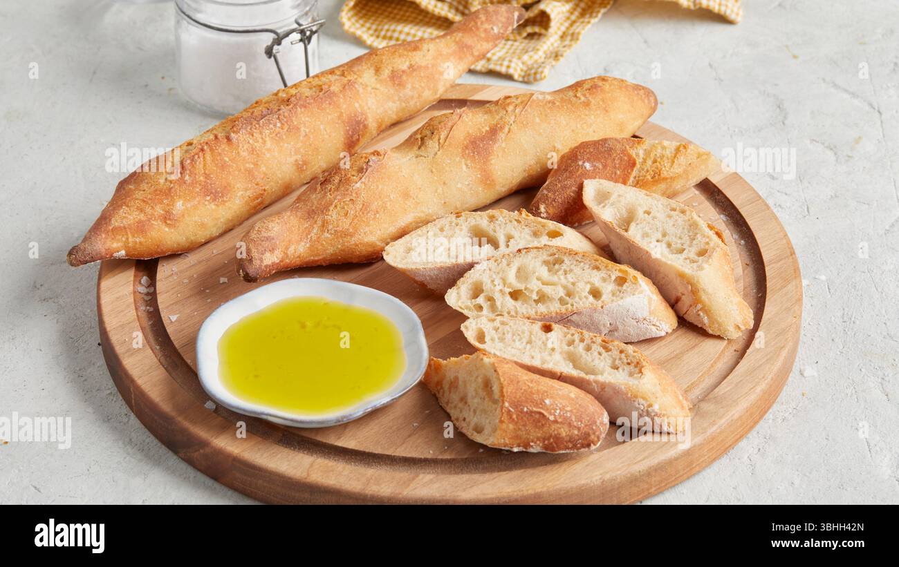 Baguette on cooling rack and wood surface – a rustic artisan loaf with ...