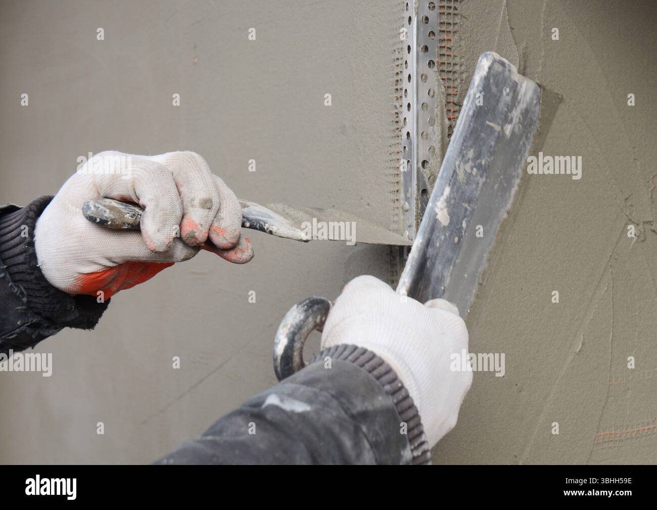 Close up on applying a coat of plaster, finish over the window angle ...