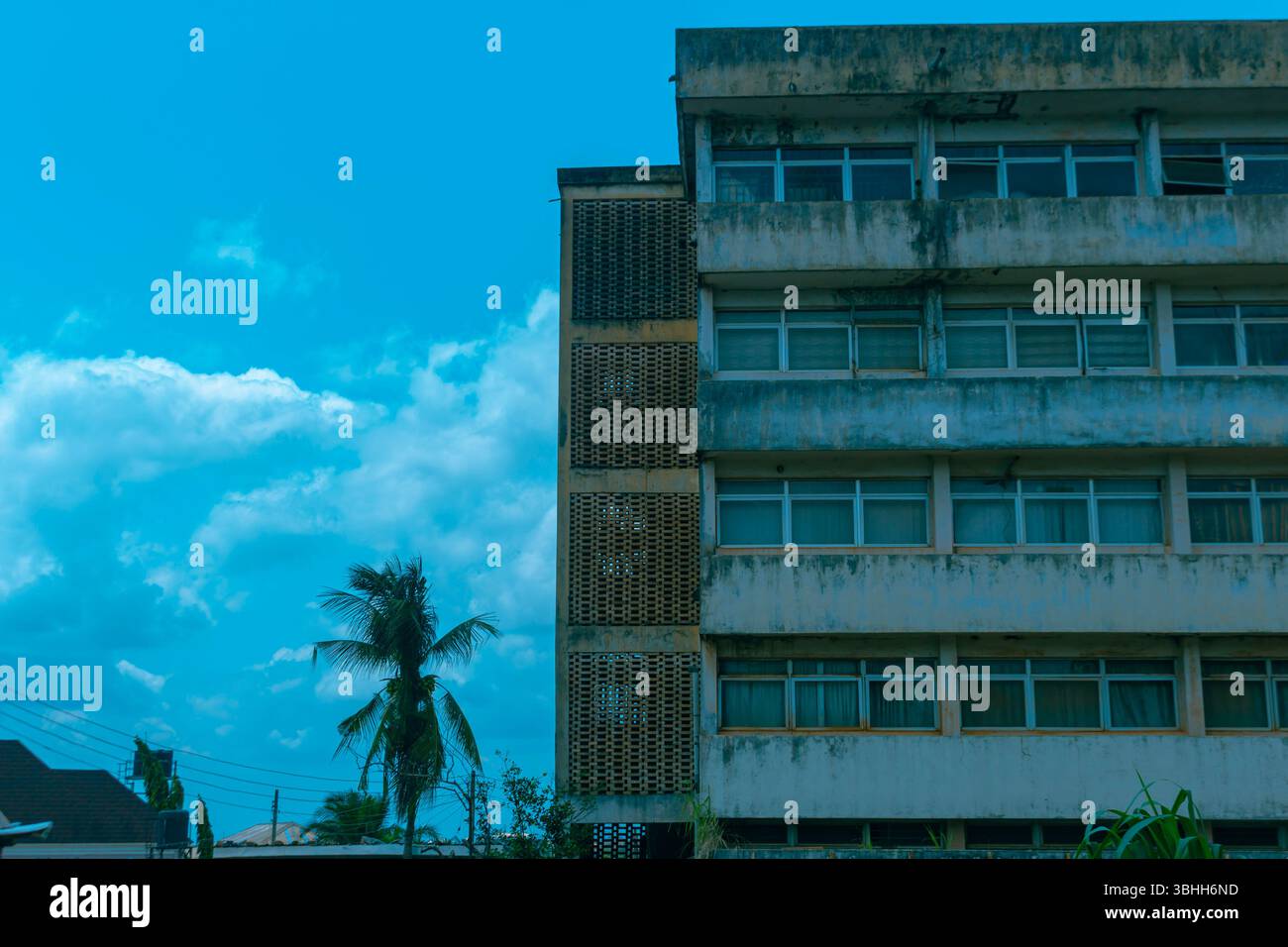 A weathered mid-century modern building with concrete sun breakers ...