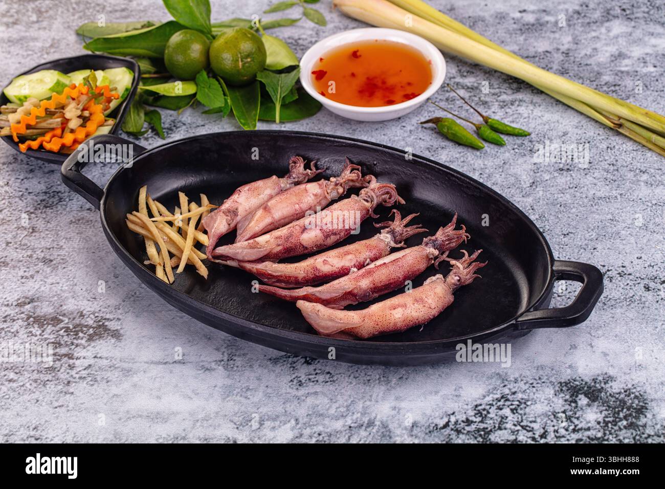 Boiled wild mini calamari snack with ginger Stock Photo - Alamy