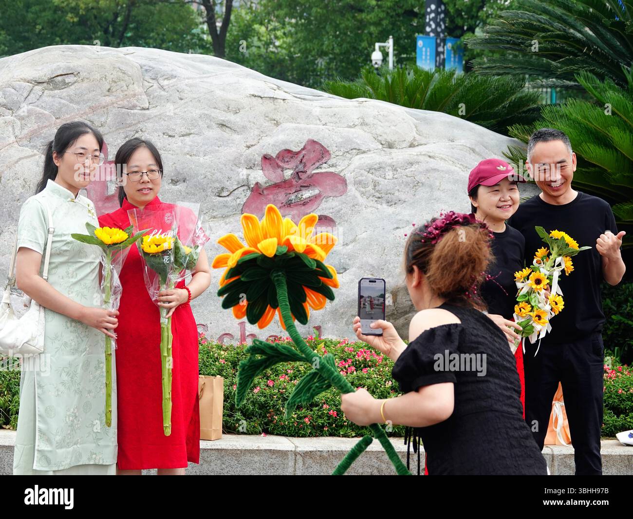 Family members cheer on the candidates outside an examination site in ...
