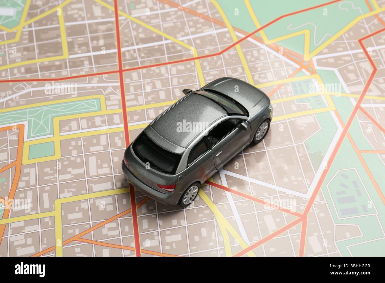 Road trip concept. Car model on city map Stock Photo - Alamy