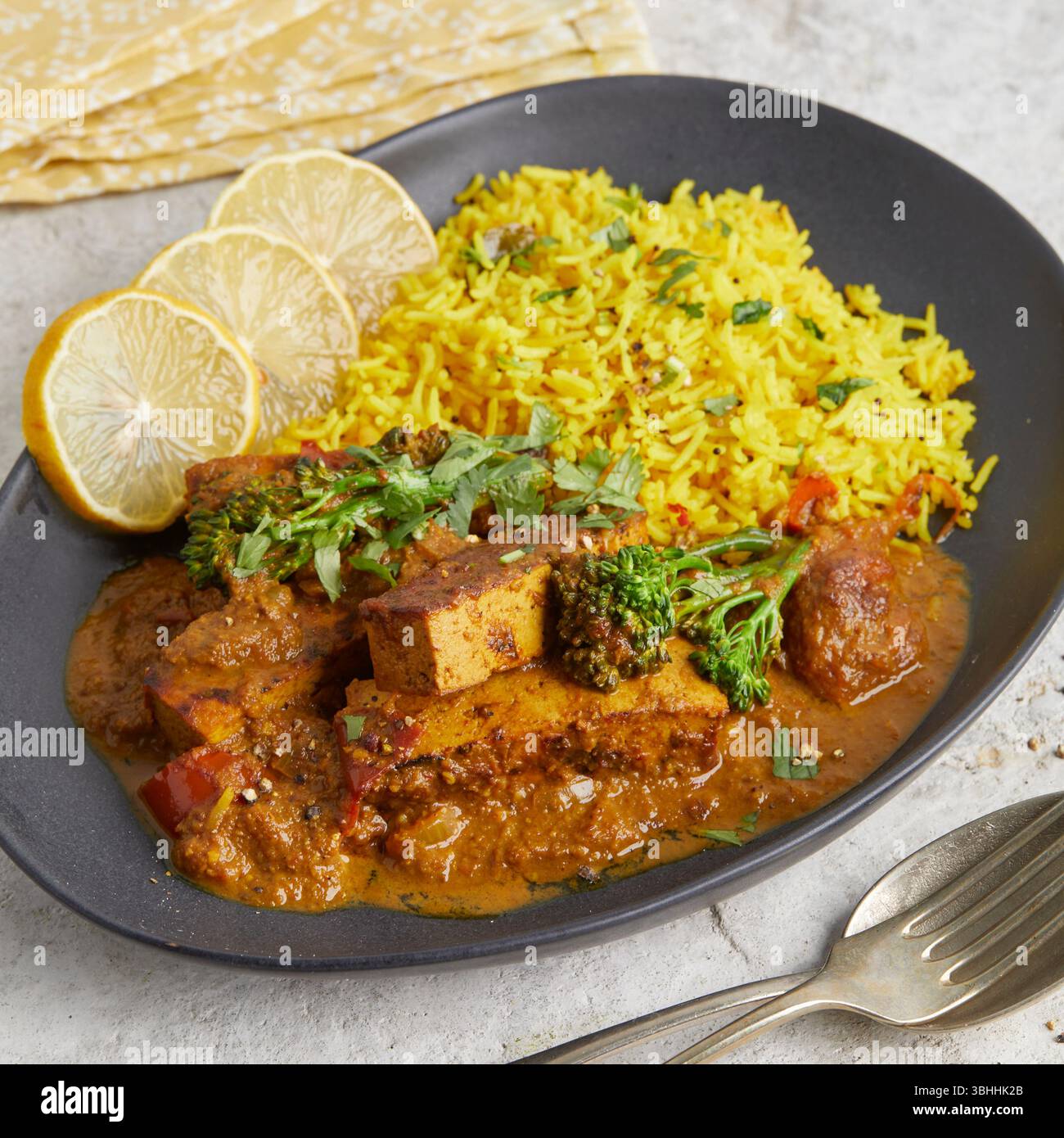 Coconut curry with tofu and yellow rice in a bowl – a creamy, plant ...
