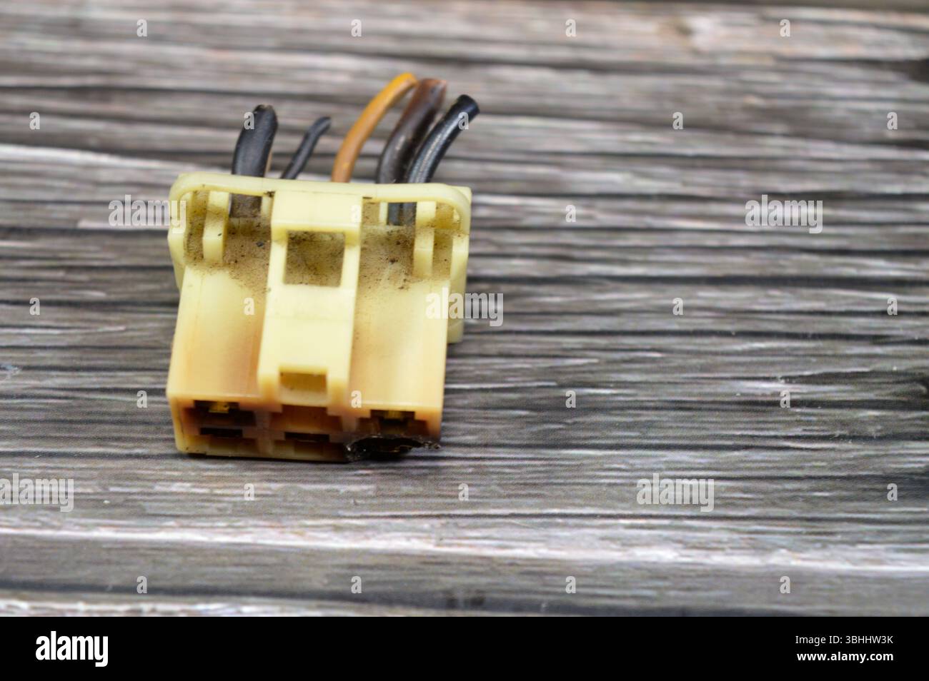 A burnt plug in the car electricity system connected to the wires that ...