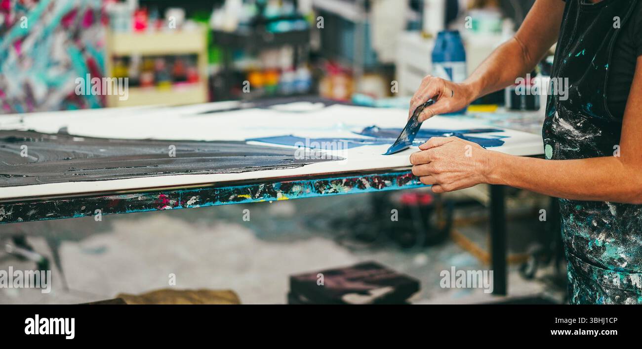 Senior woman painting inside her atelier studio at home - Artist female ...