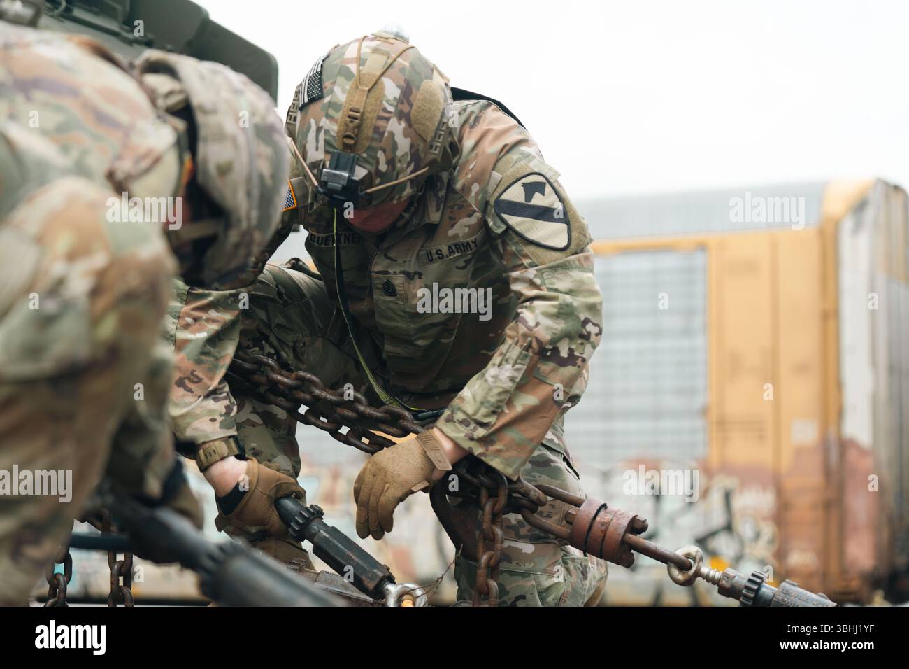 A U.S. Army Soldier assigned to the 1st Cavalry Division, unchains a ...