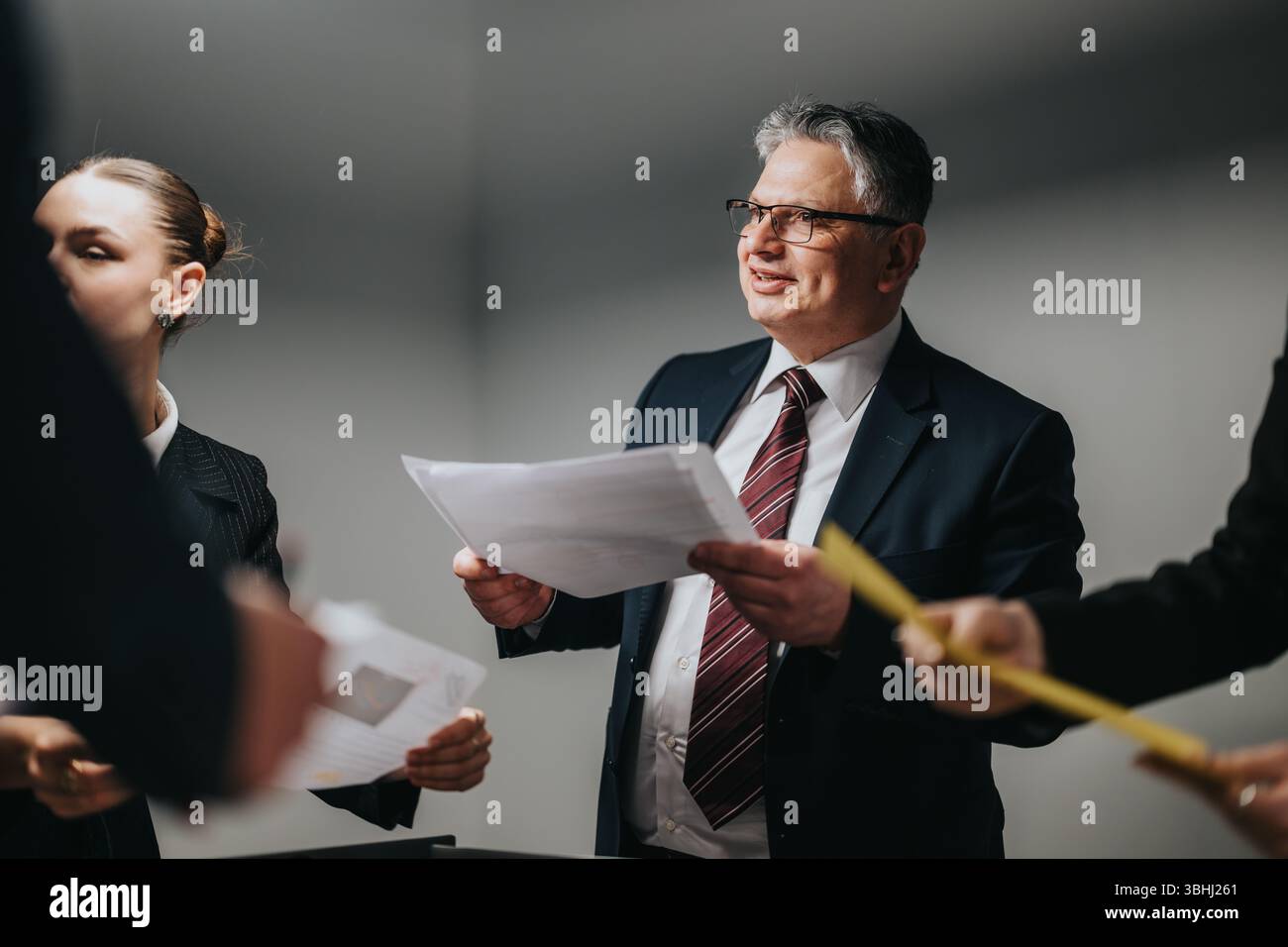 Mature professional engaging in a collaborative business discussion ...