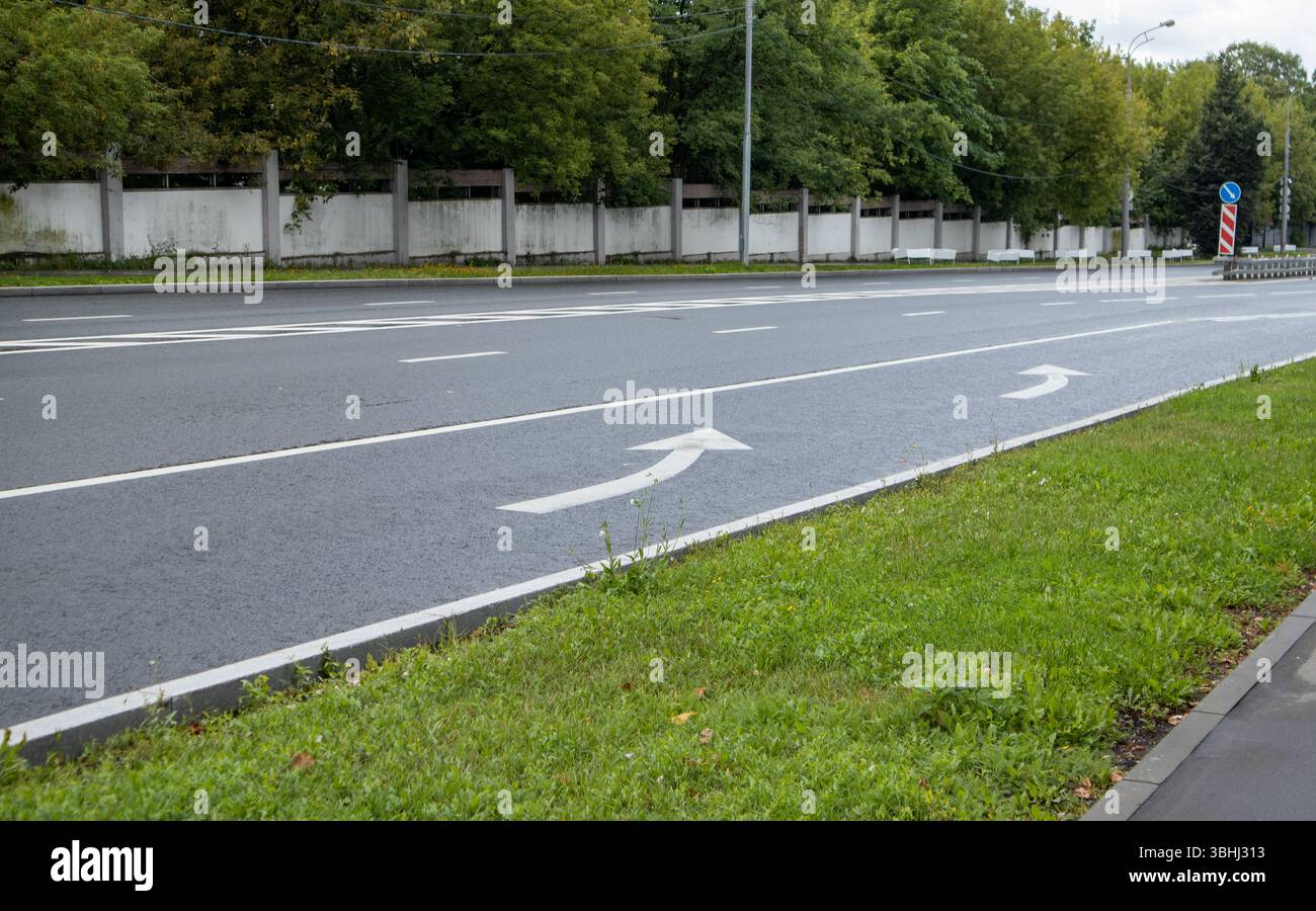 Asphalt roadway with an arrow pointing to the end of the lane pointing ...